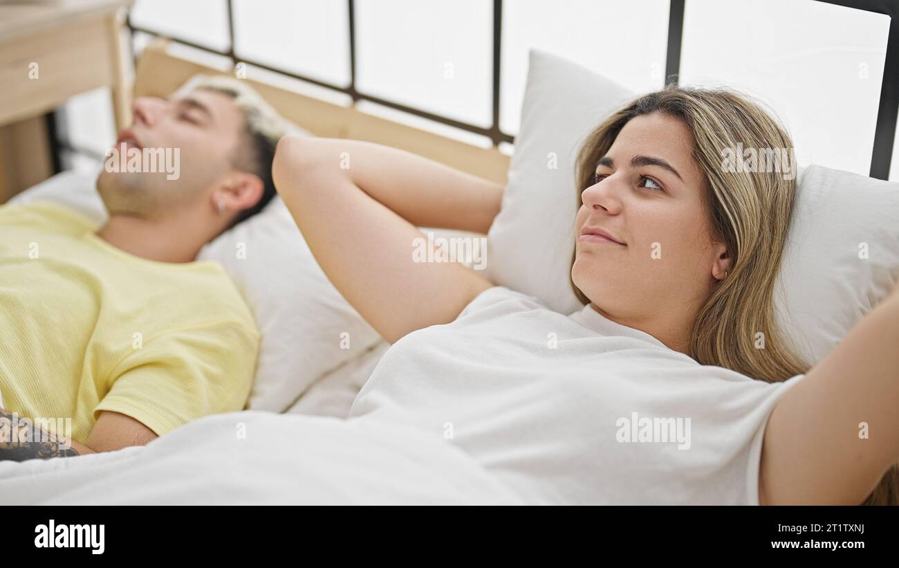 Beautiful couple covering ears for snore lying on bed at bedroom Stock ...