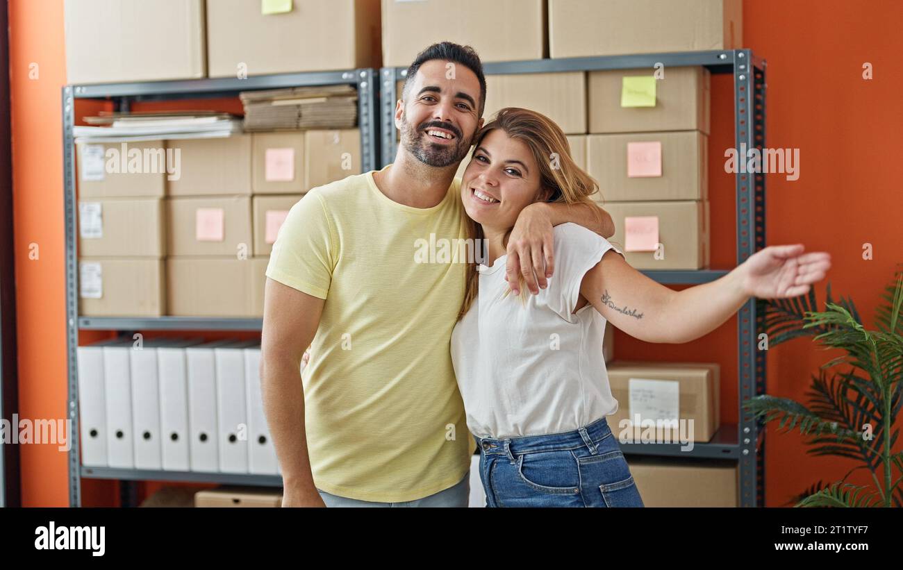 Man and woman ecommerce business workers hugging each other smiling at ...