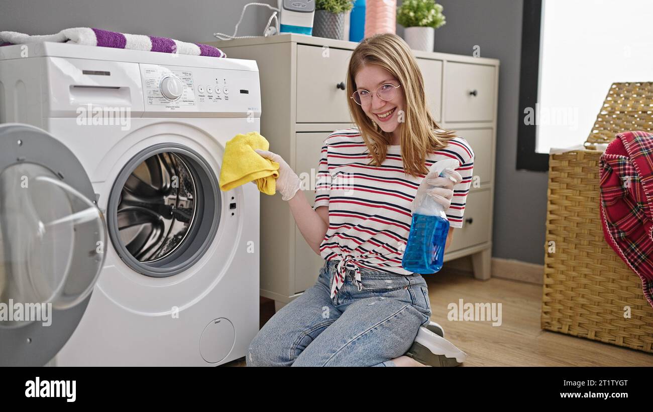 Young blonde woman cleaning washing machine at laundry room Stock Photo ...