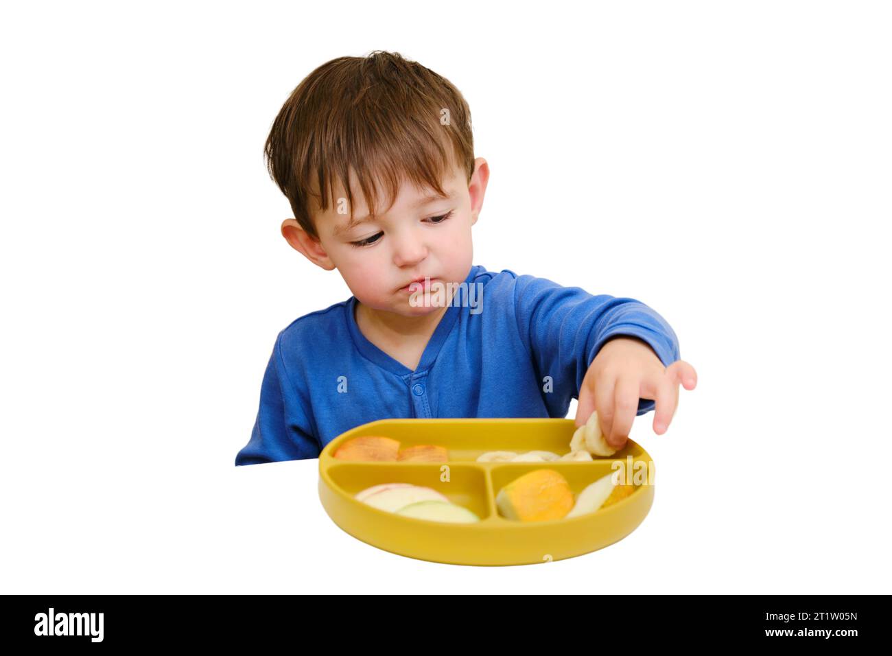 Happy child with plate full of fruits and berries, sitting at the table ...
