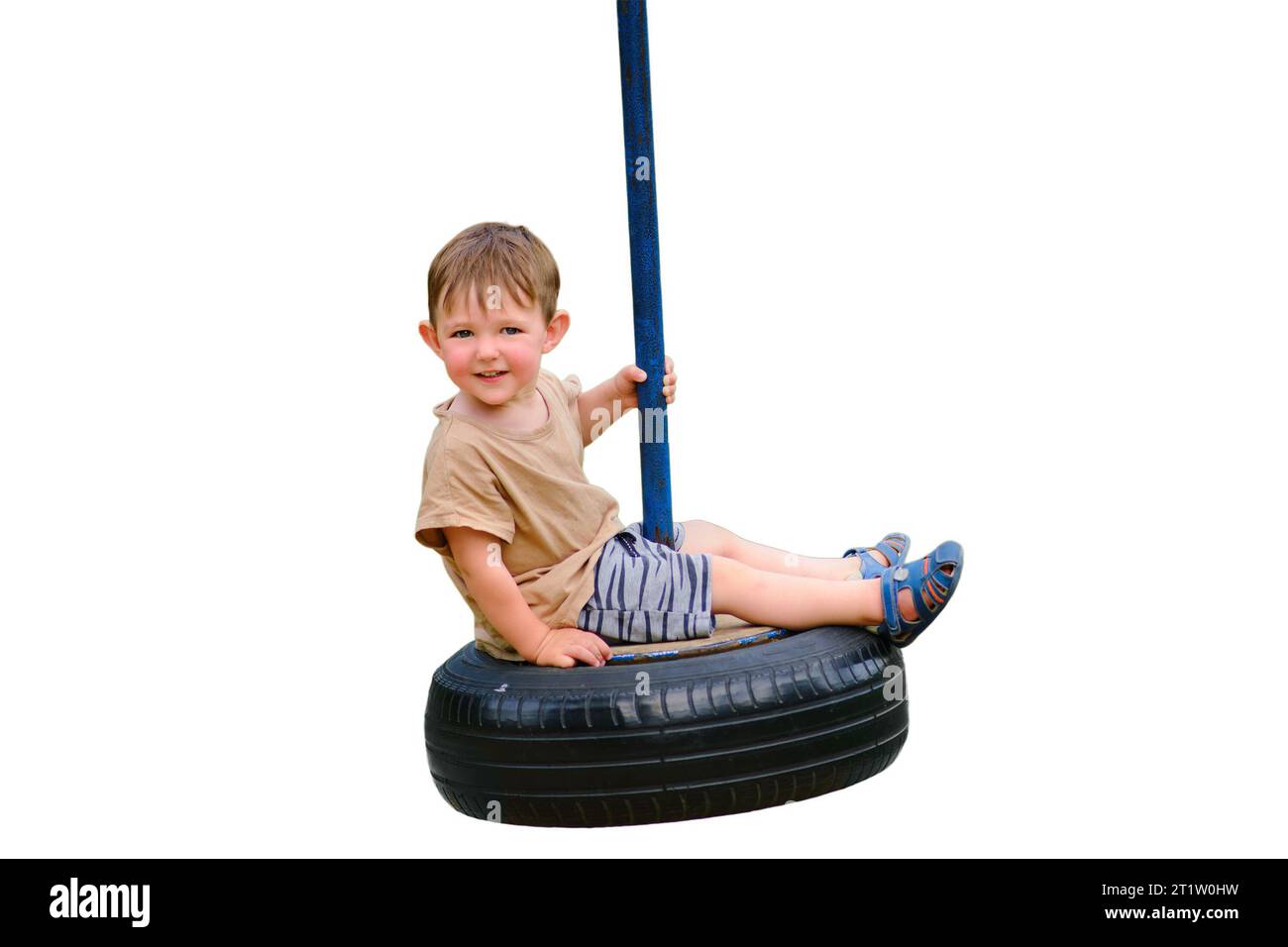 A smiling child enjoys playing on a car tire turned into a swing ...