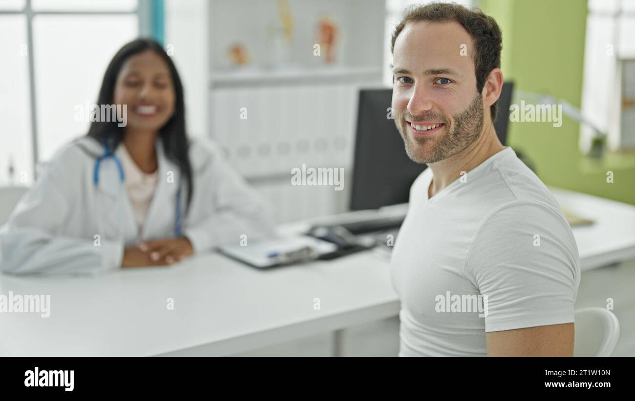 Doctor and patient sitting on table smiling at the clinic Stock Photo ...