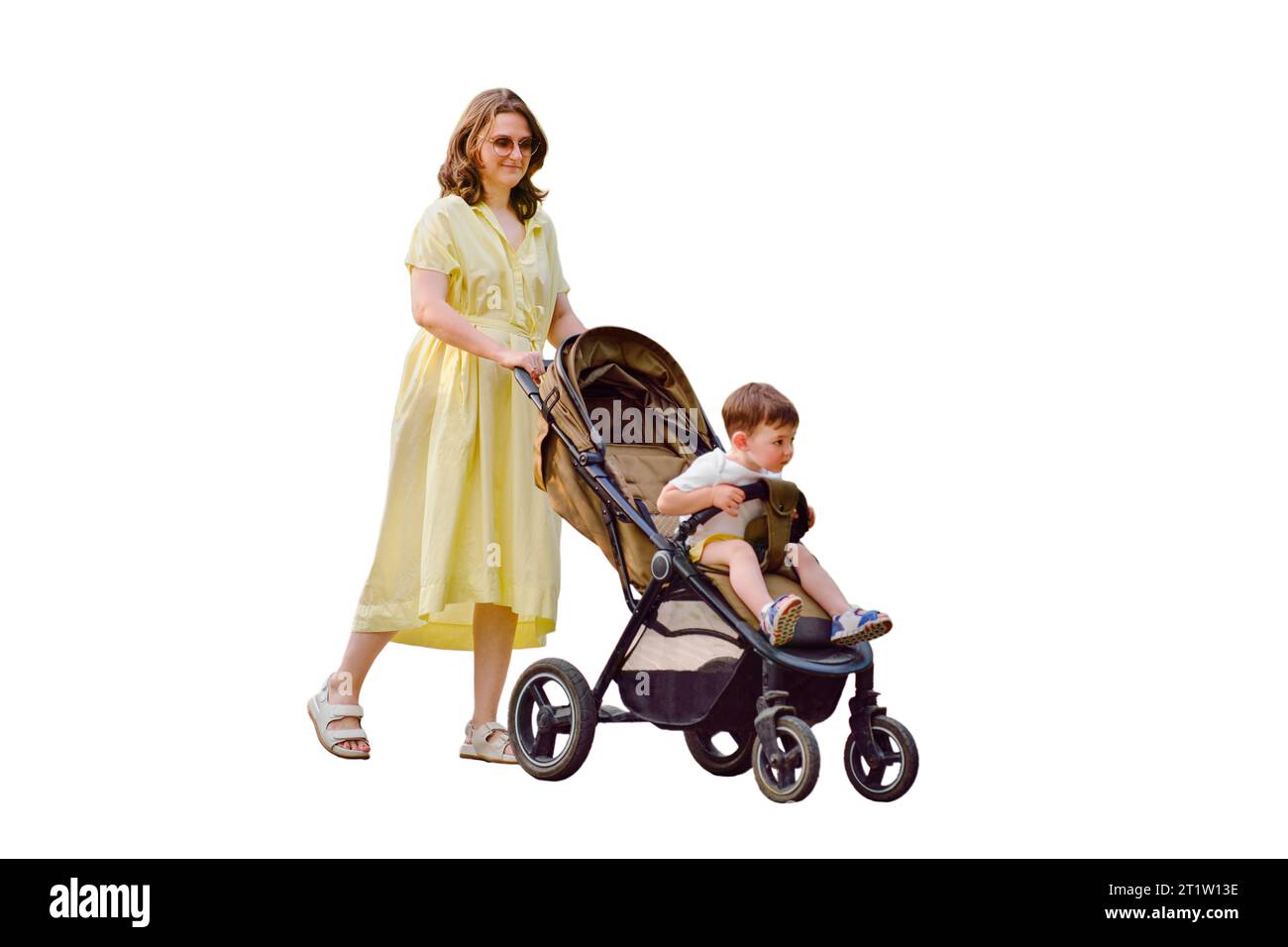 A mother woman walks with a toddler baby in a stroller walking along a ...