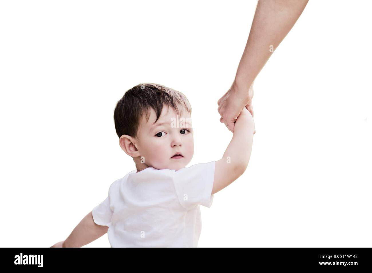 Child boy looks back with fear in his eyes, clutching his mother's hand ...