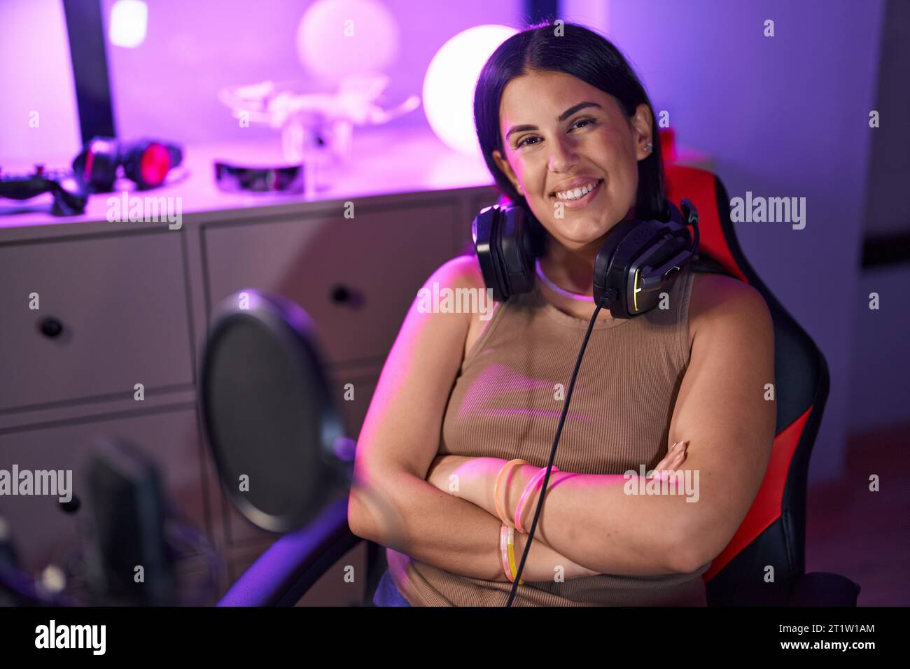 Young beautiful hispanic woman streamer smiling confident sitting with ...