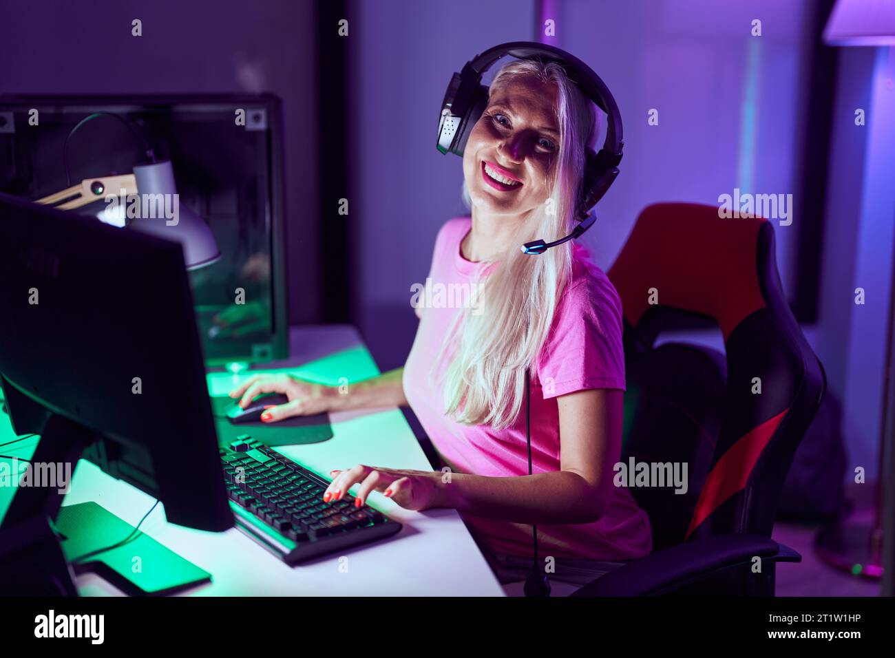 Young blonde woman streamer smiling confident using computer at gaming ...