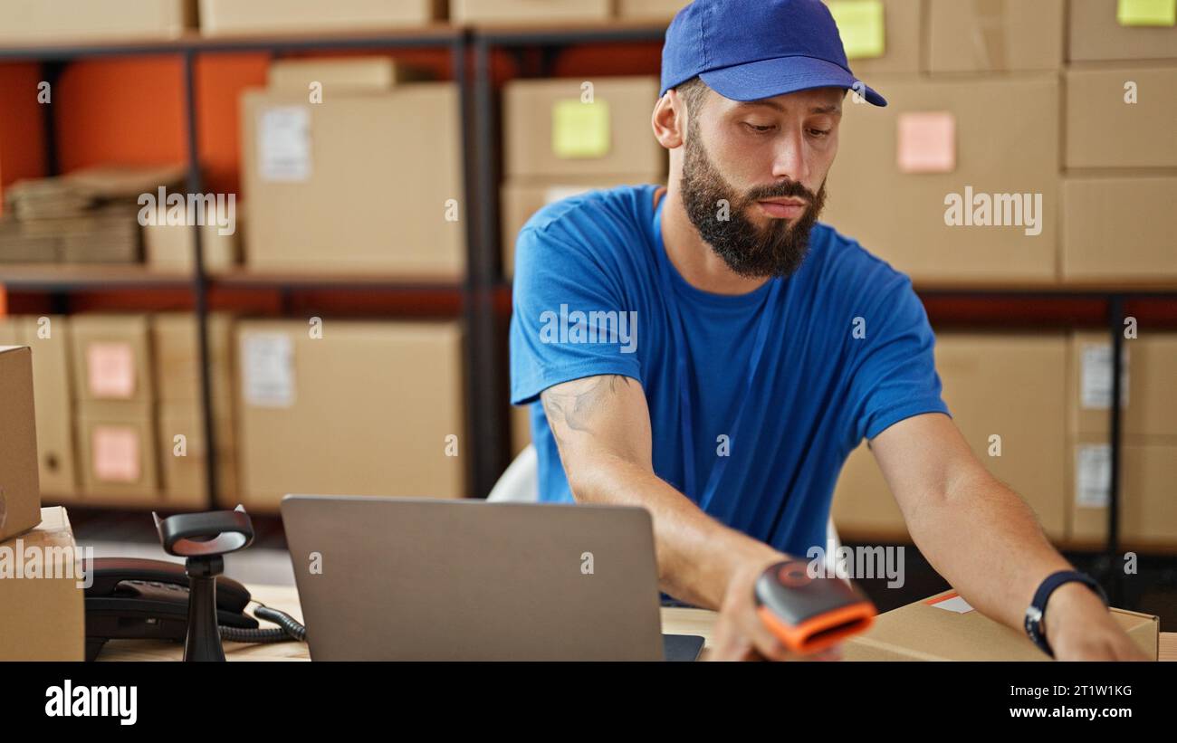 Young hispanic man ecommerce worker scanning packages at office Stock ...