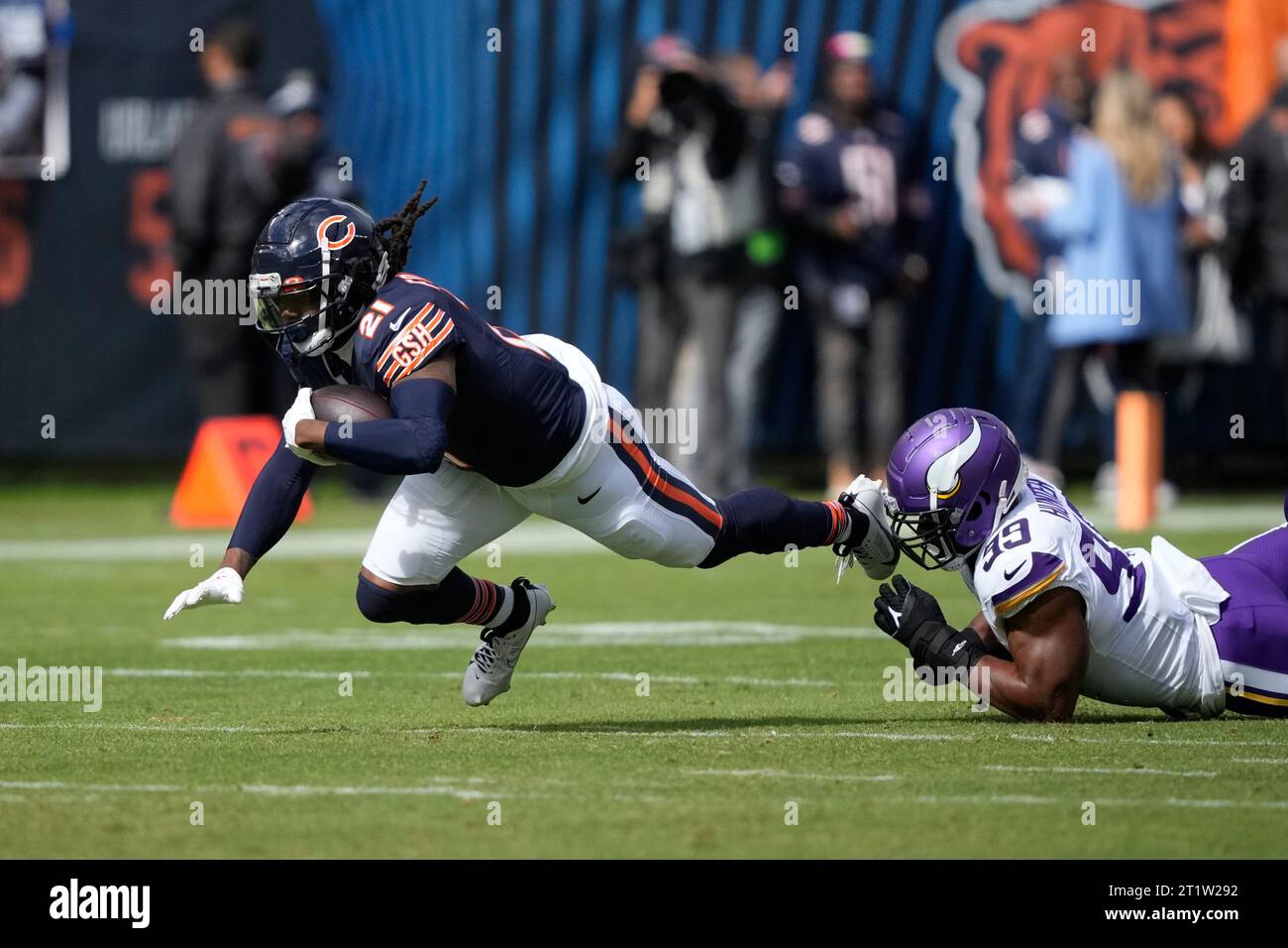 Chicago Bears running back D'Onta Foreman (21) is tripped by Minnesota ...