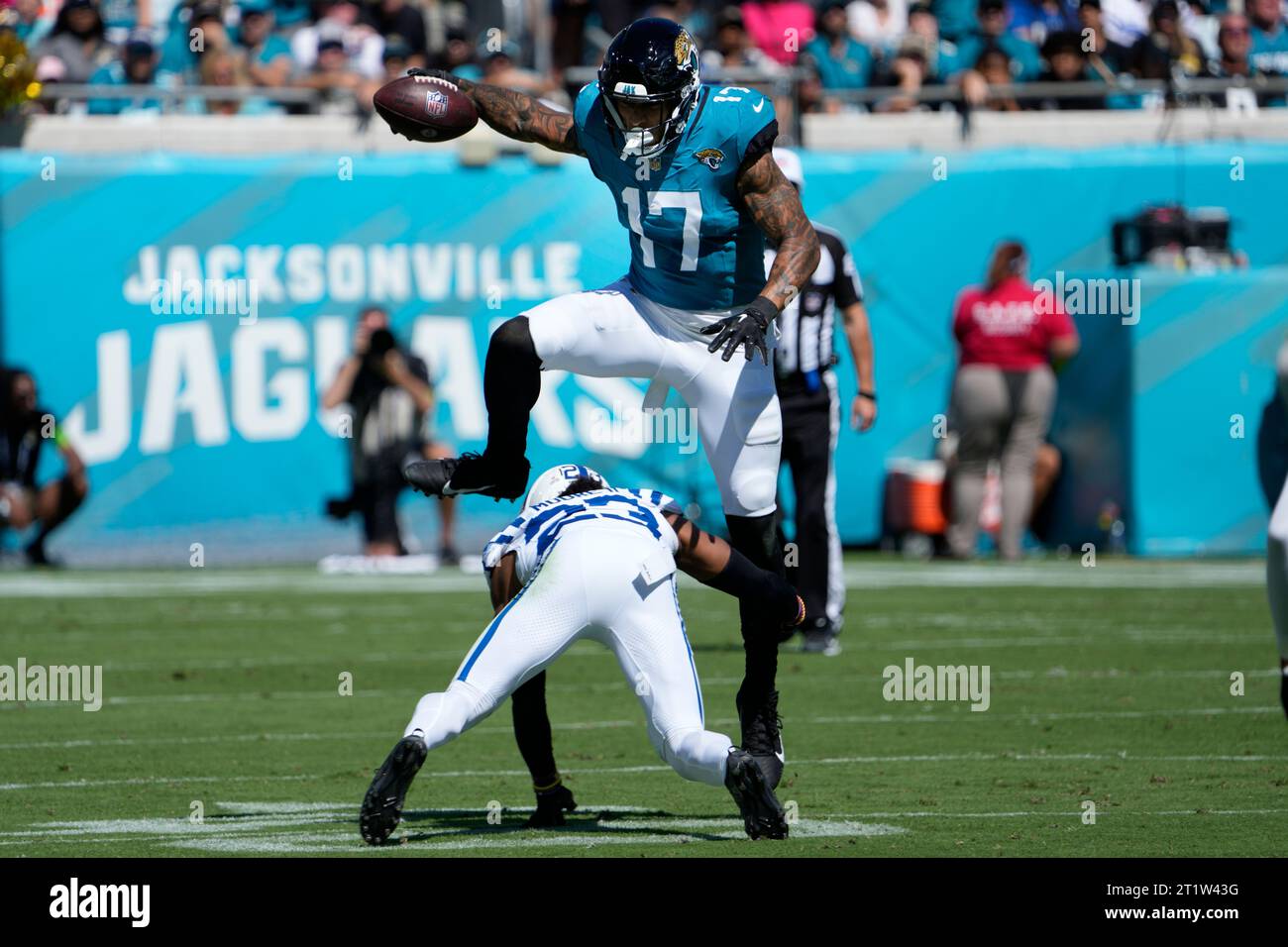 Jacksonville Jaguars tight end Evan Engram (17) leaps over Indianapolis Colts cornerback Kenny ...