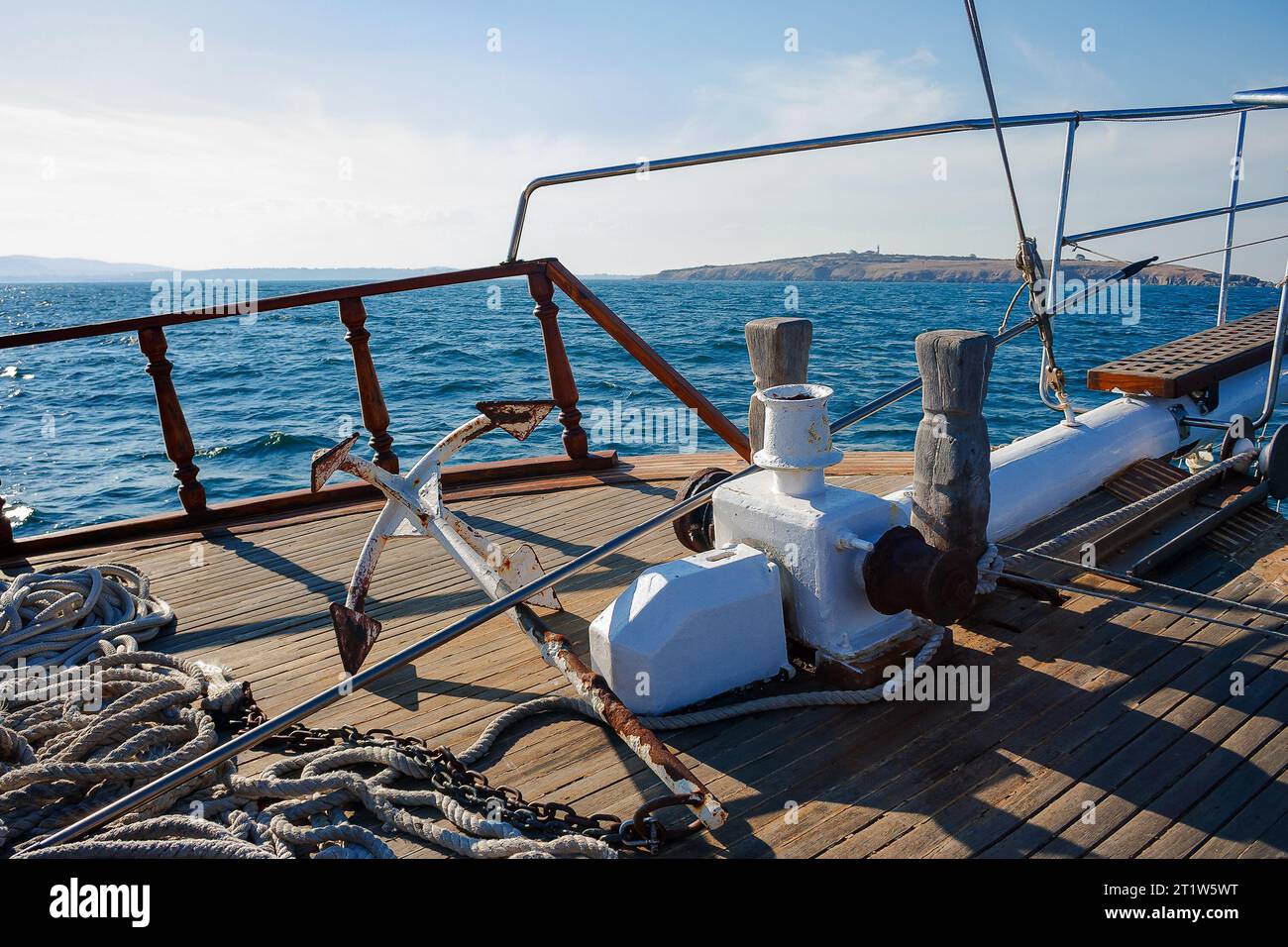 view from the nose of a ship in open sea. island in the distance on the ...