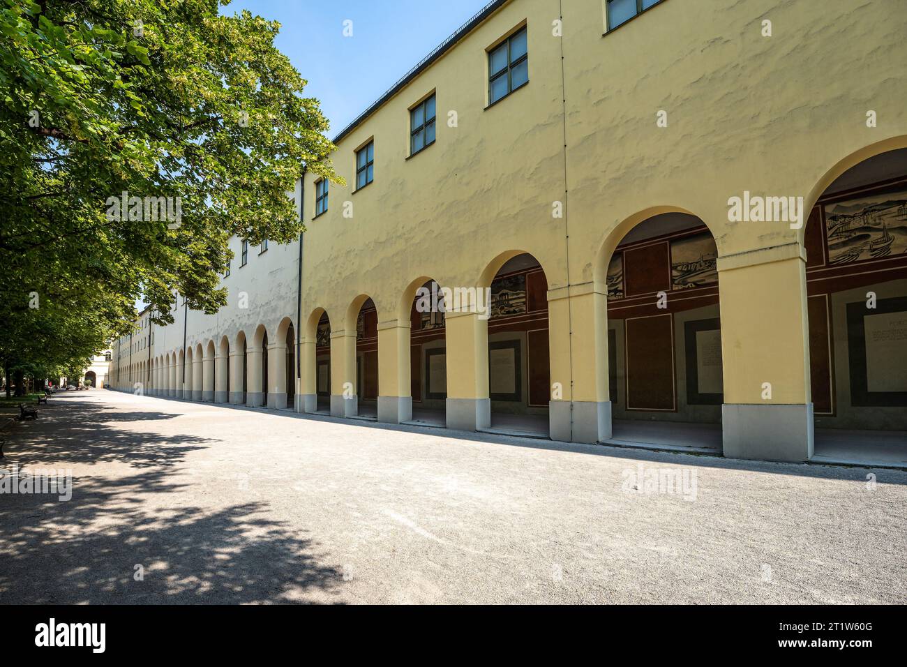 Promenade with long arcade columns surrounding Hofgarten Park in Munich ...