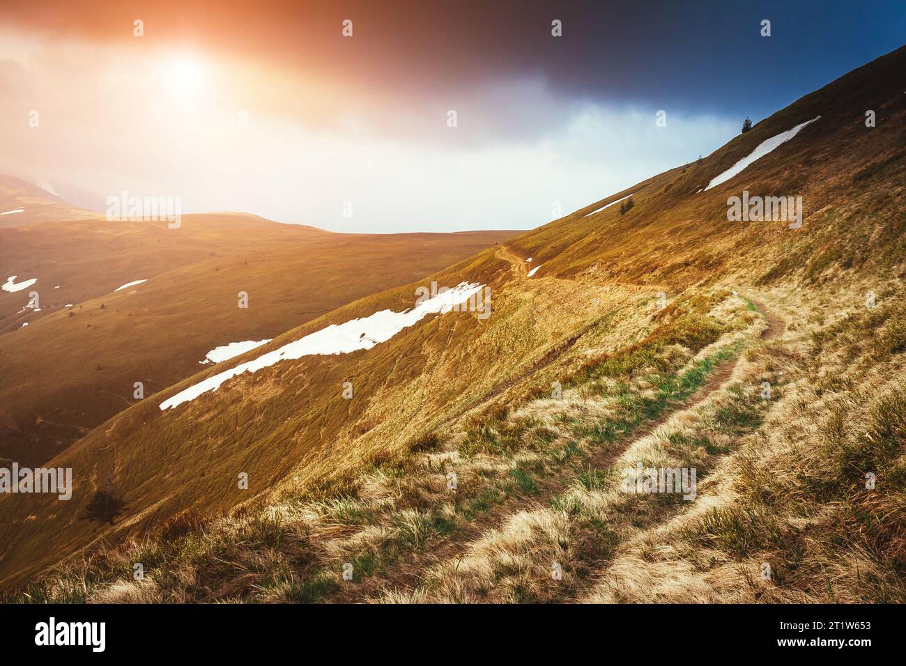 Gloomy view of the snow range under overcast sky. Dramatic scene and ...