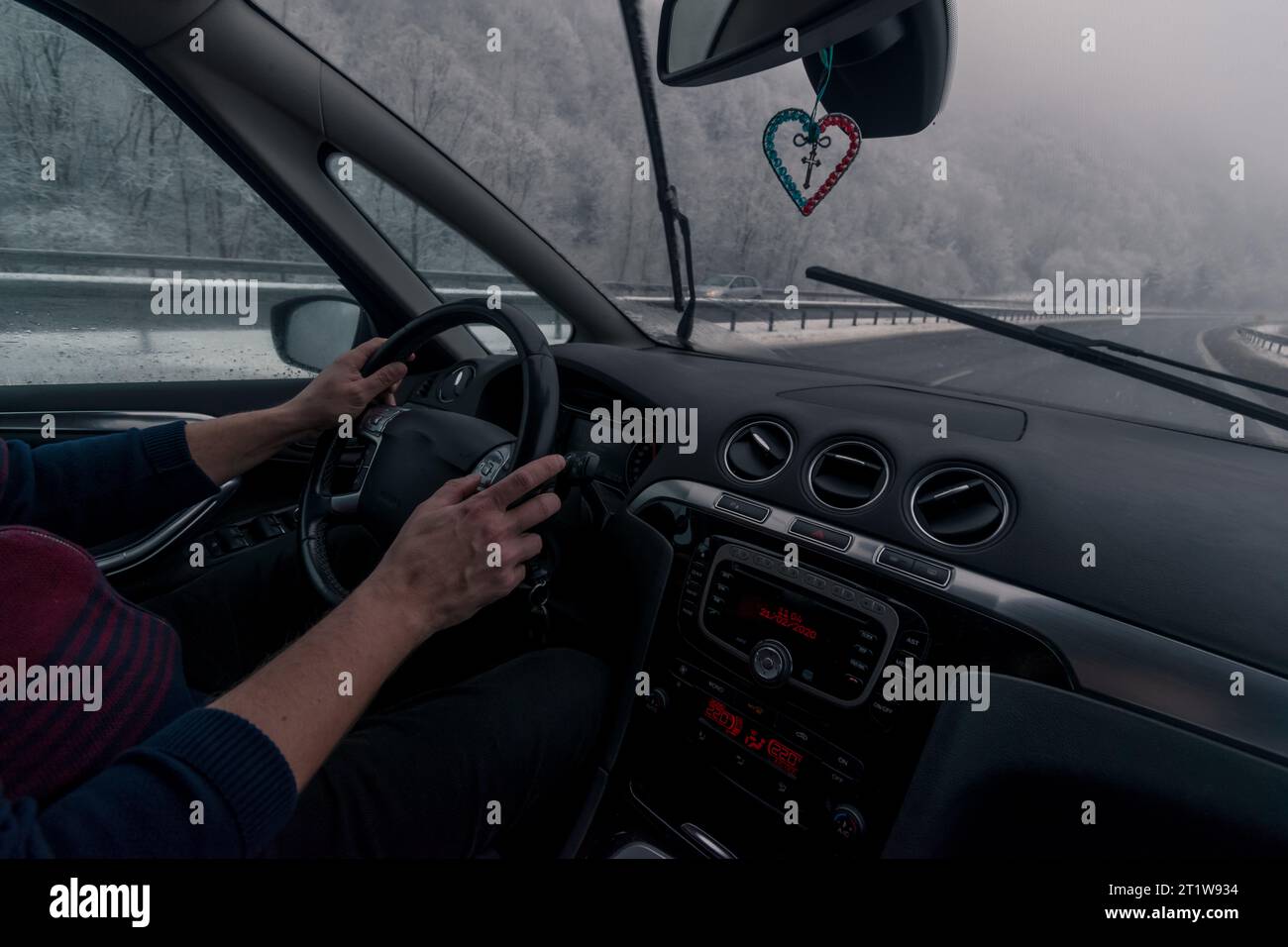 hands on wheel driving a car, view from inside Stock Photo - Alamy