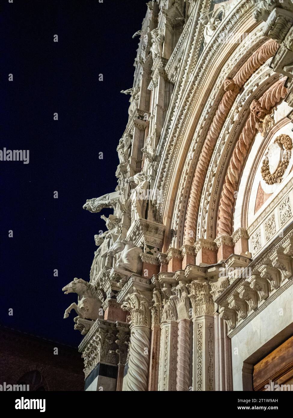 Looking up to the sone carvings covering the left corner of Siena ...