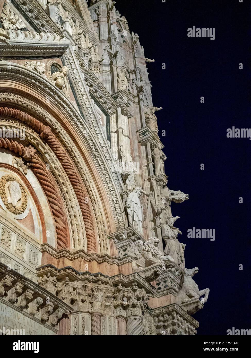 Looking up to the sone carvings covering the right corner of Siena ...