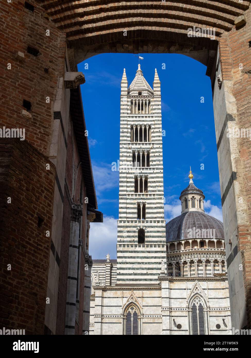 Siena Duomo bell tower framed by the Facciatone Stock Photo - Alamy