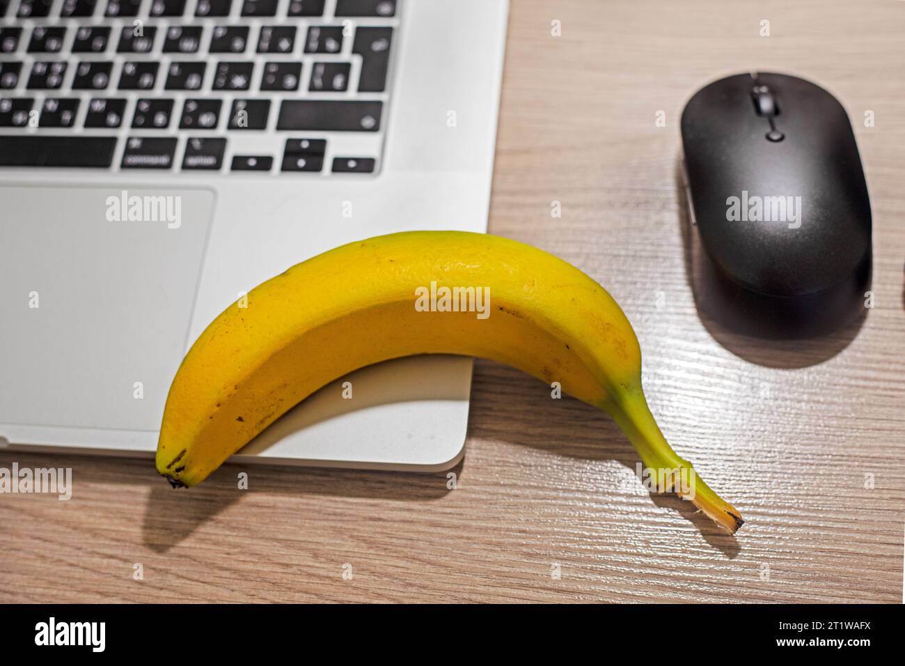 banana on the table near the computer with a computer mouse. snack ...