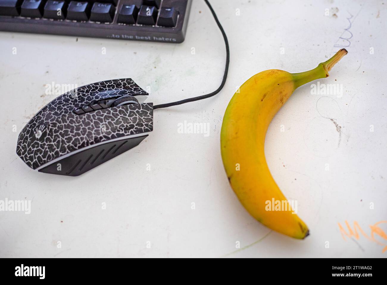 banana on the table near the computer with a computer mouse. snack ...