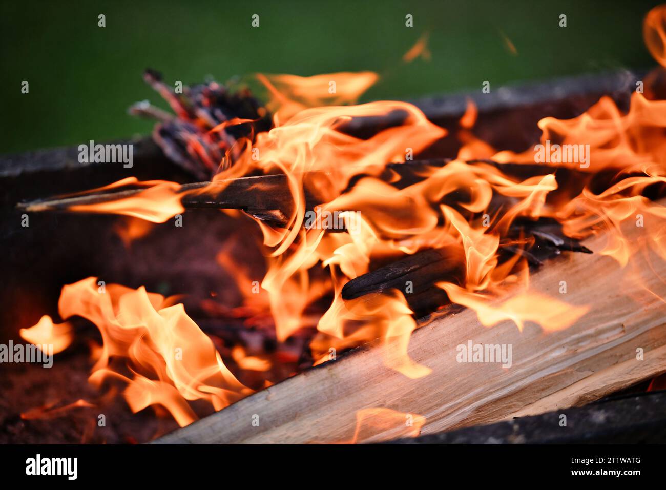 Burning log of wood close-up as abstract background. The hot embers of ...