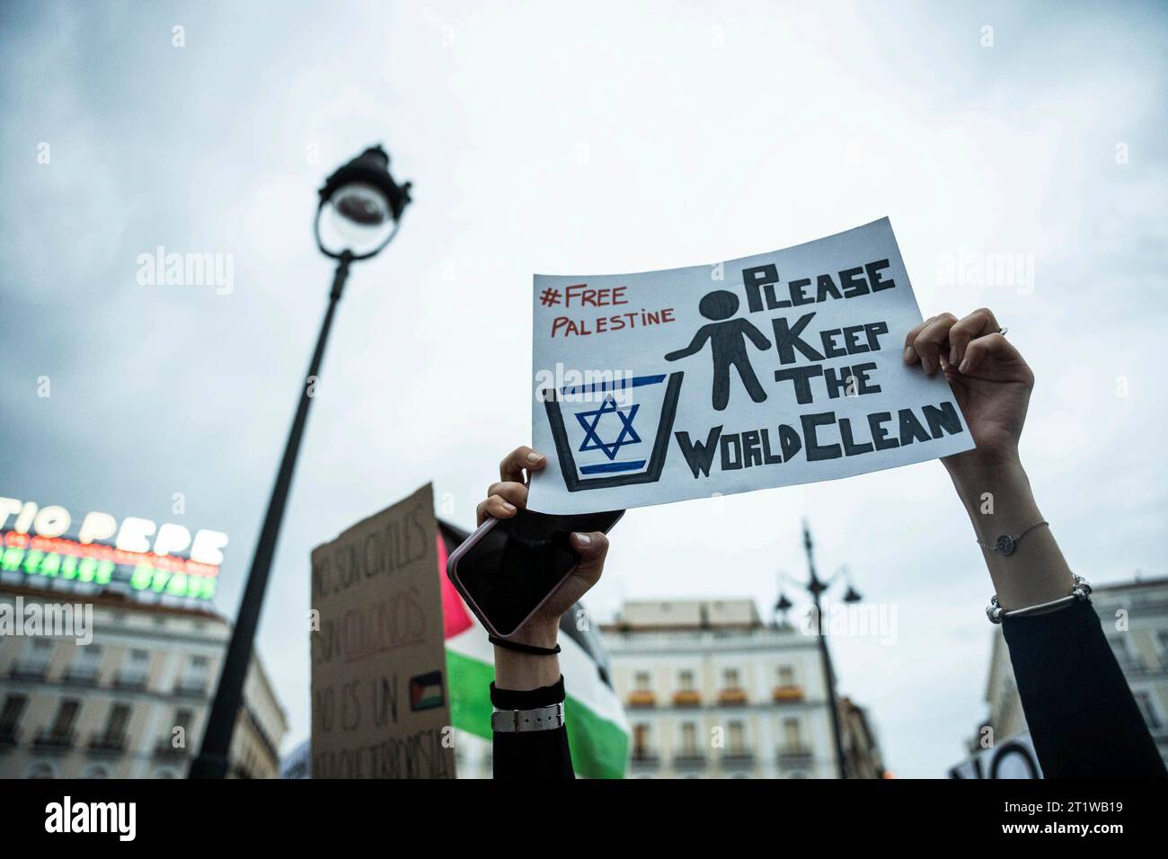 A person with a sign reading 'Please keep the world clean', during a ...