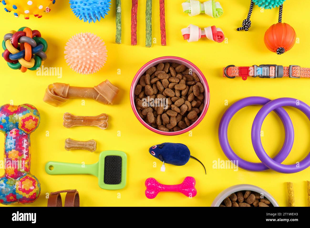 Flat lay composition with different pet goods on yellow background ...