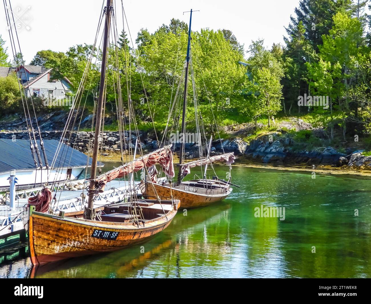 A bustling marina filled with several boats tied together in the water ...