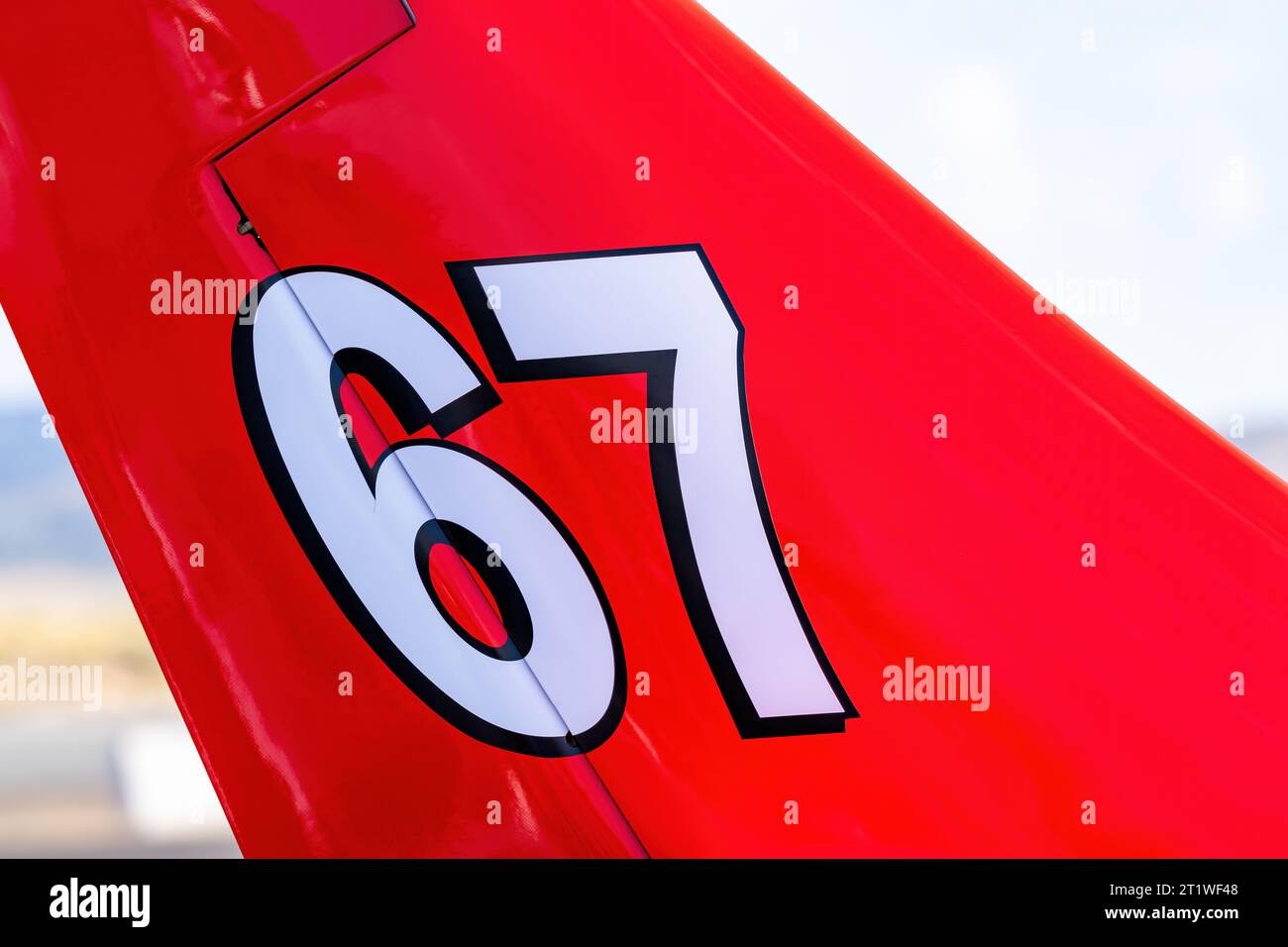 Red tail of an airplane with tail number 67 Stock Photo - Alamy