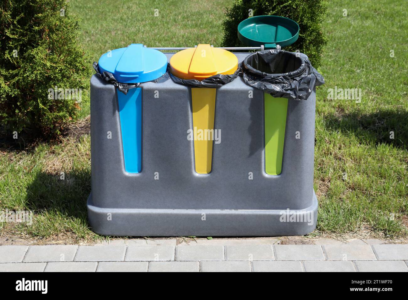 Recycling bins for different garbage outdoors. Waste sorting Stock ...