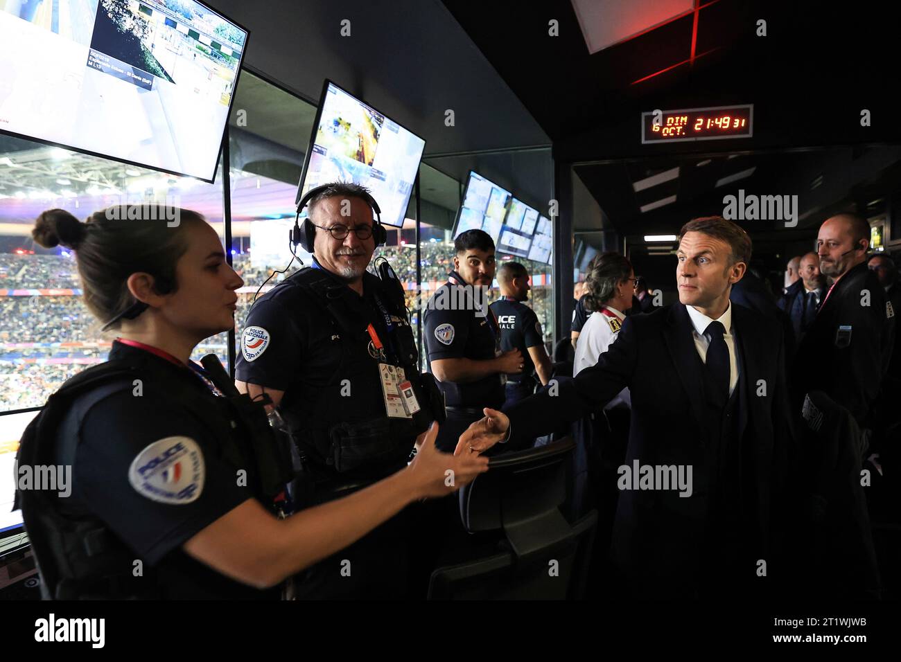 French President Emmanuel Macron shakes hands to a police officer as he ...