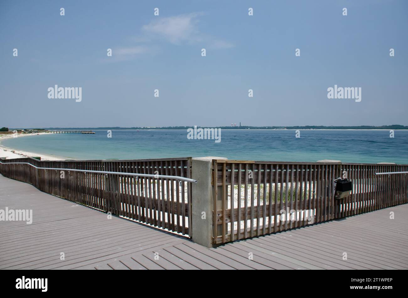 Wooden walkway leading to the beach and pier with view of the sea ...