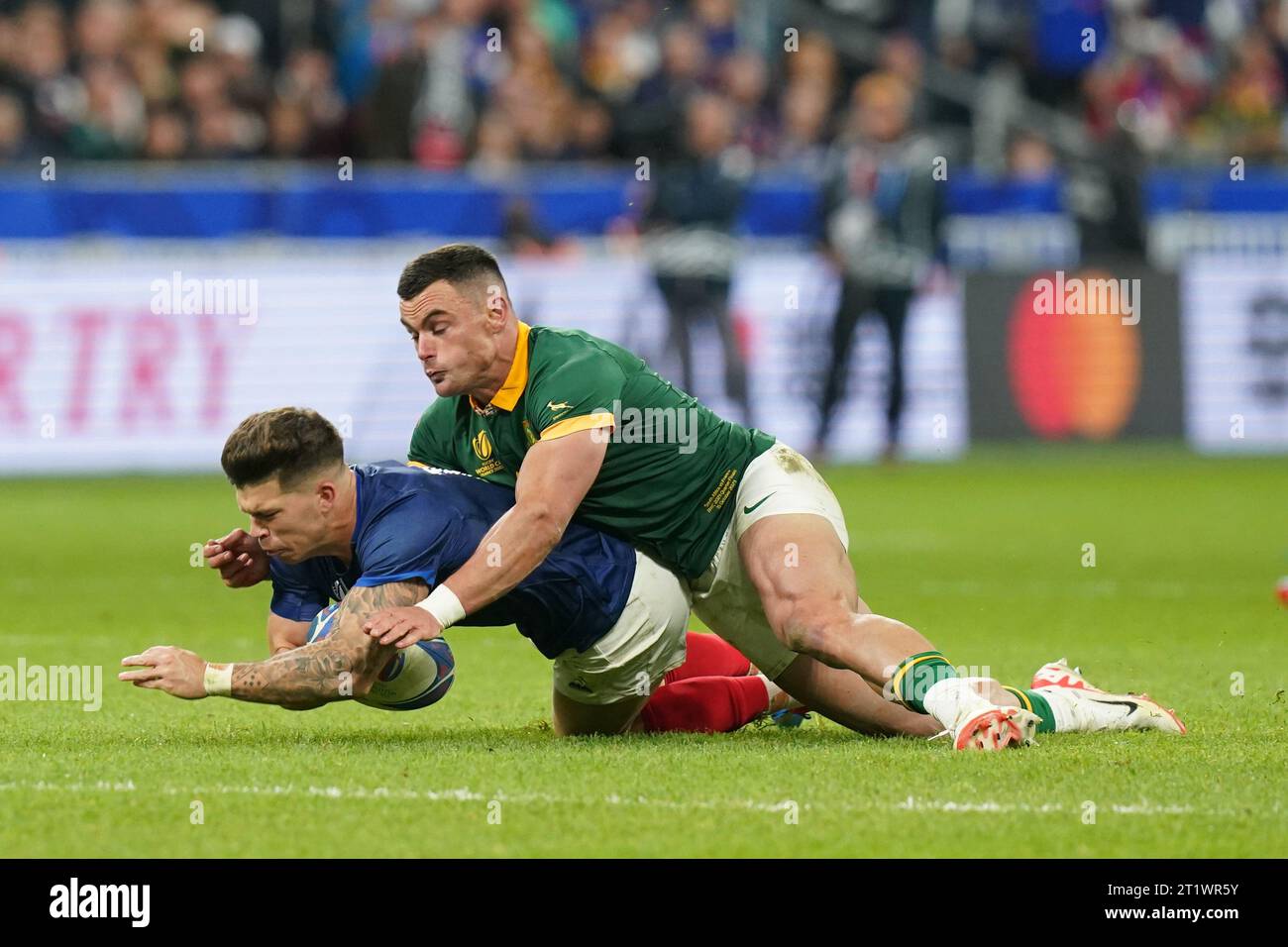 France's Matthieu Jalibert (left) is tackled by South Africa's Jesse ...