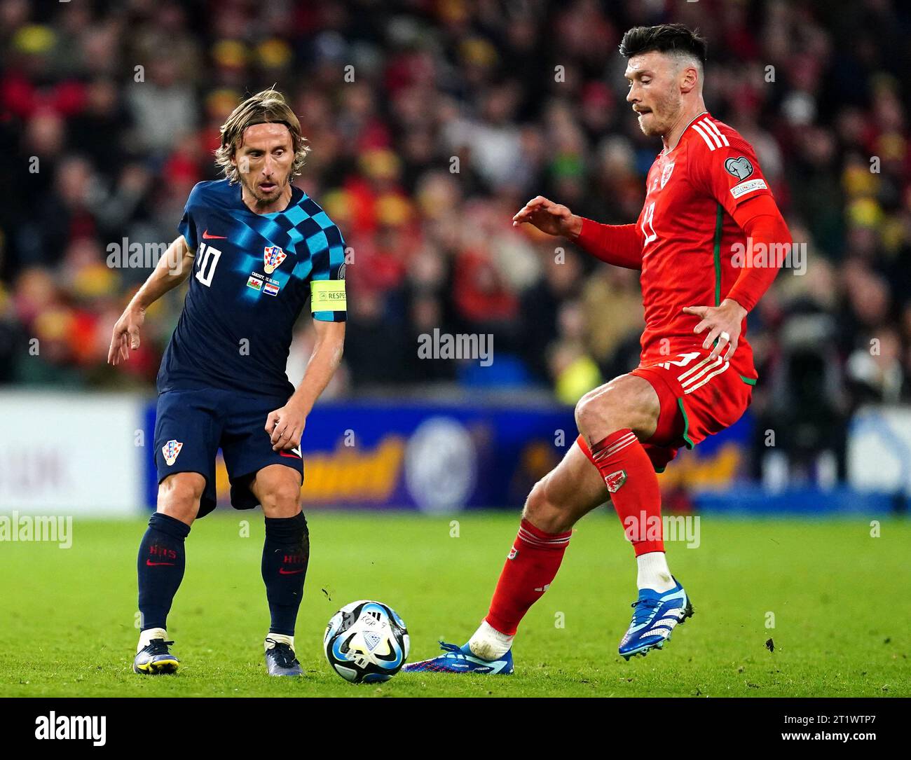 Croatia's Luka Modric (left) and Wales' Kieffer Moore battle for the ...