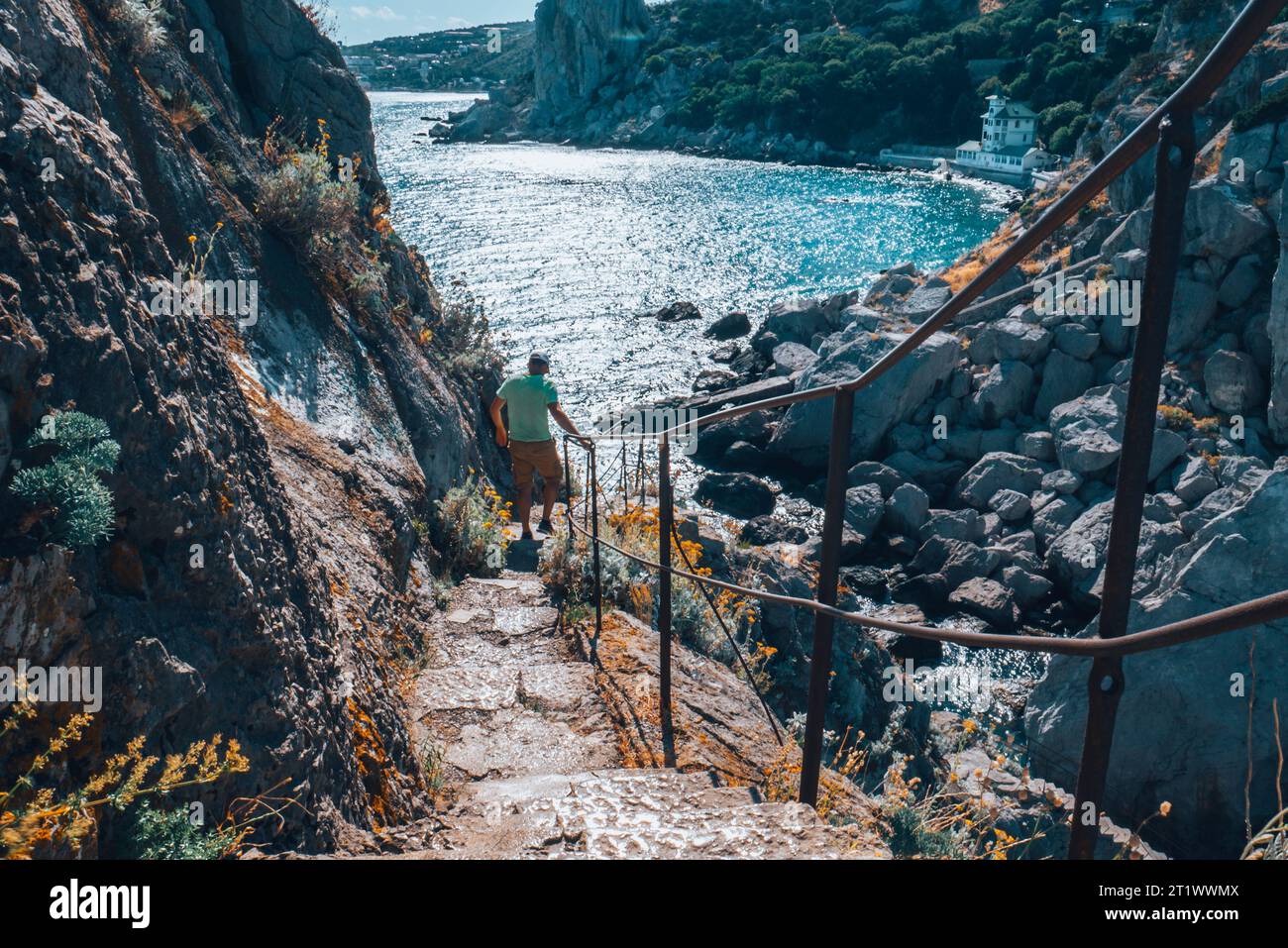A man descends from a dangerous old staircase Stock Photo - Alamy