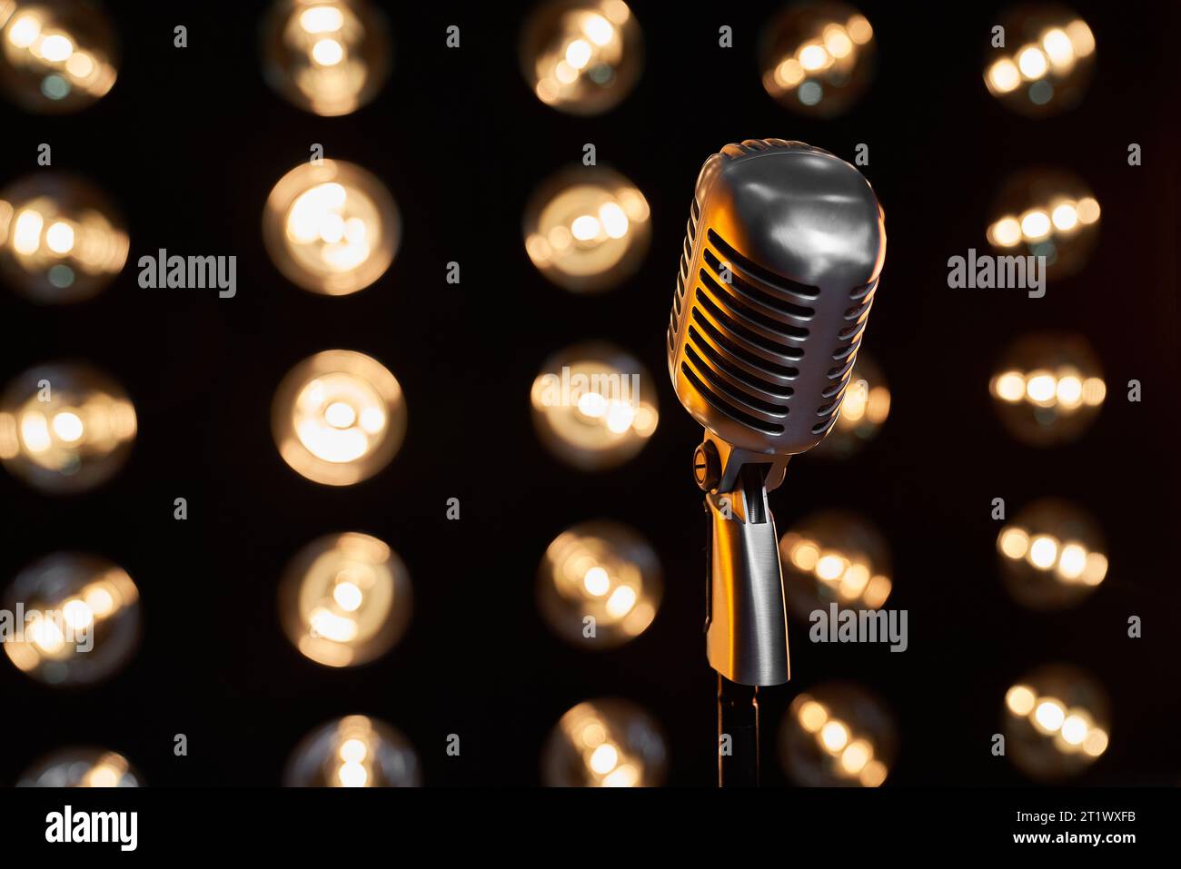 Retro microphone lightly illuminated with spotlight stage light, placed ...