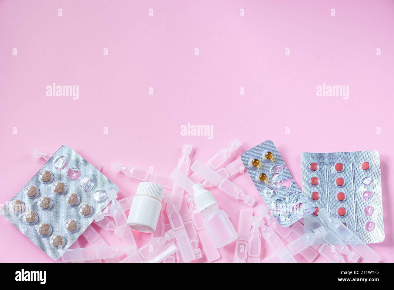 Medications and medical ampoules on pink background. Tablets, drugs and ...