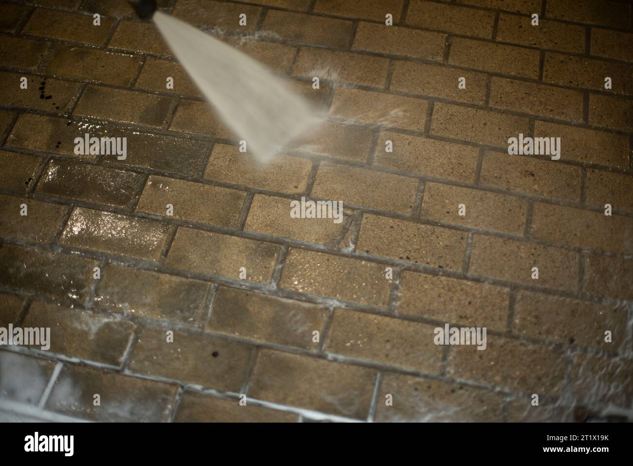 Rinsing dirt off tiles. The flow of water on the floor. Housekeeping ...