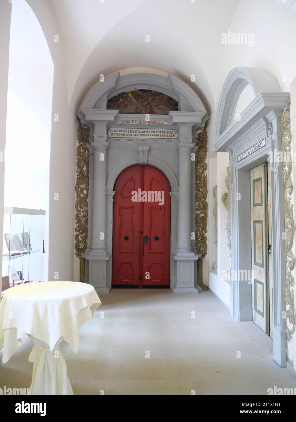 Historical portal with red door in the cloister of Schöntal monastery ...