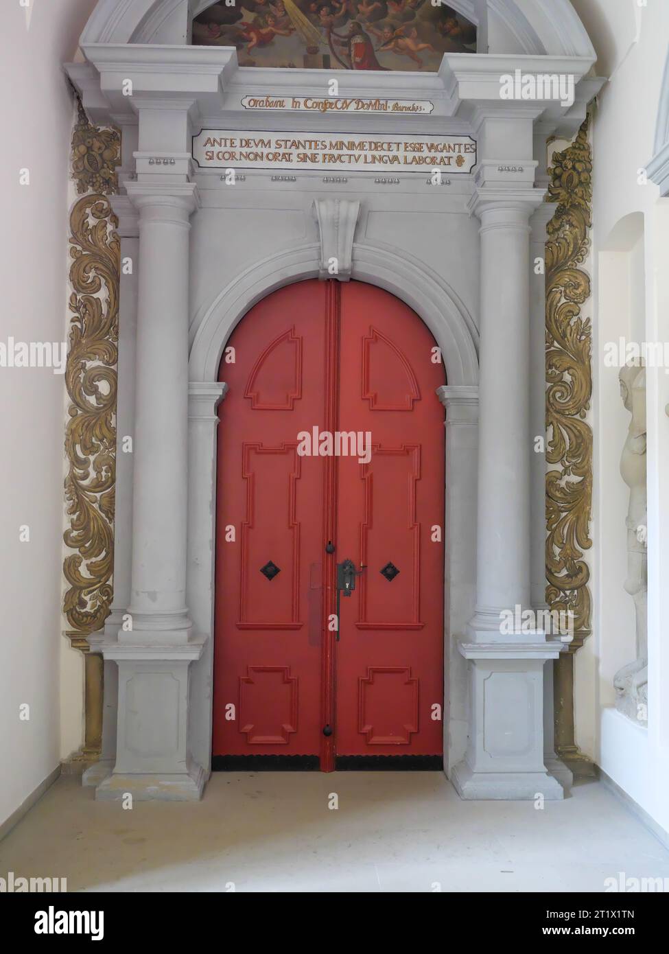Historical portal with red door in the cloister of Schöntal monastery ...