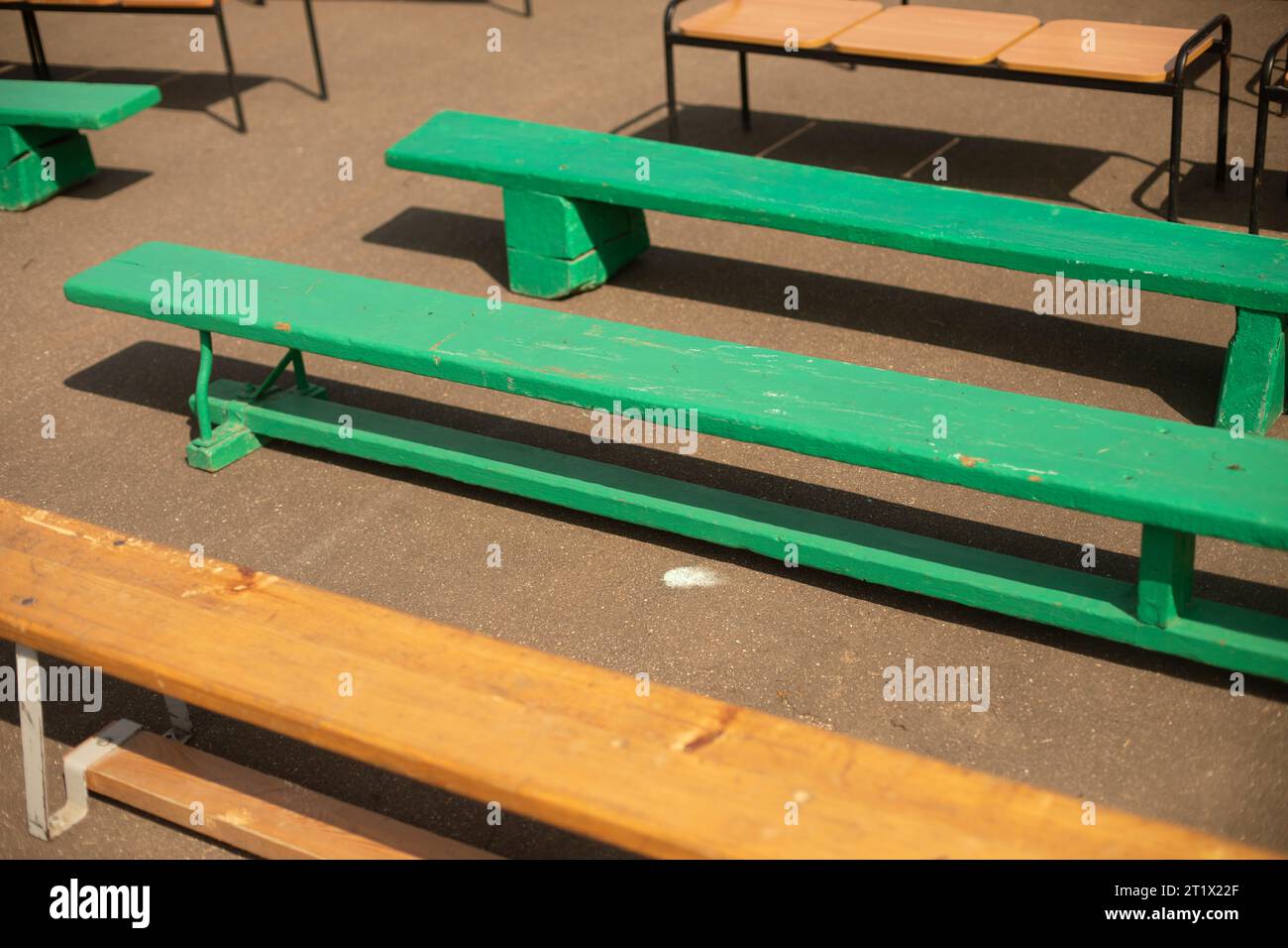 Empty seats. Places for guests. Benches stand in row on street ...