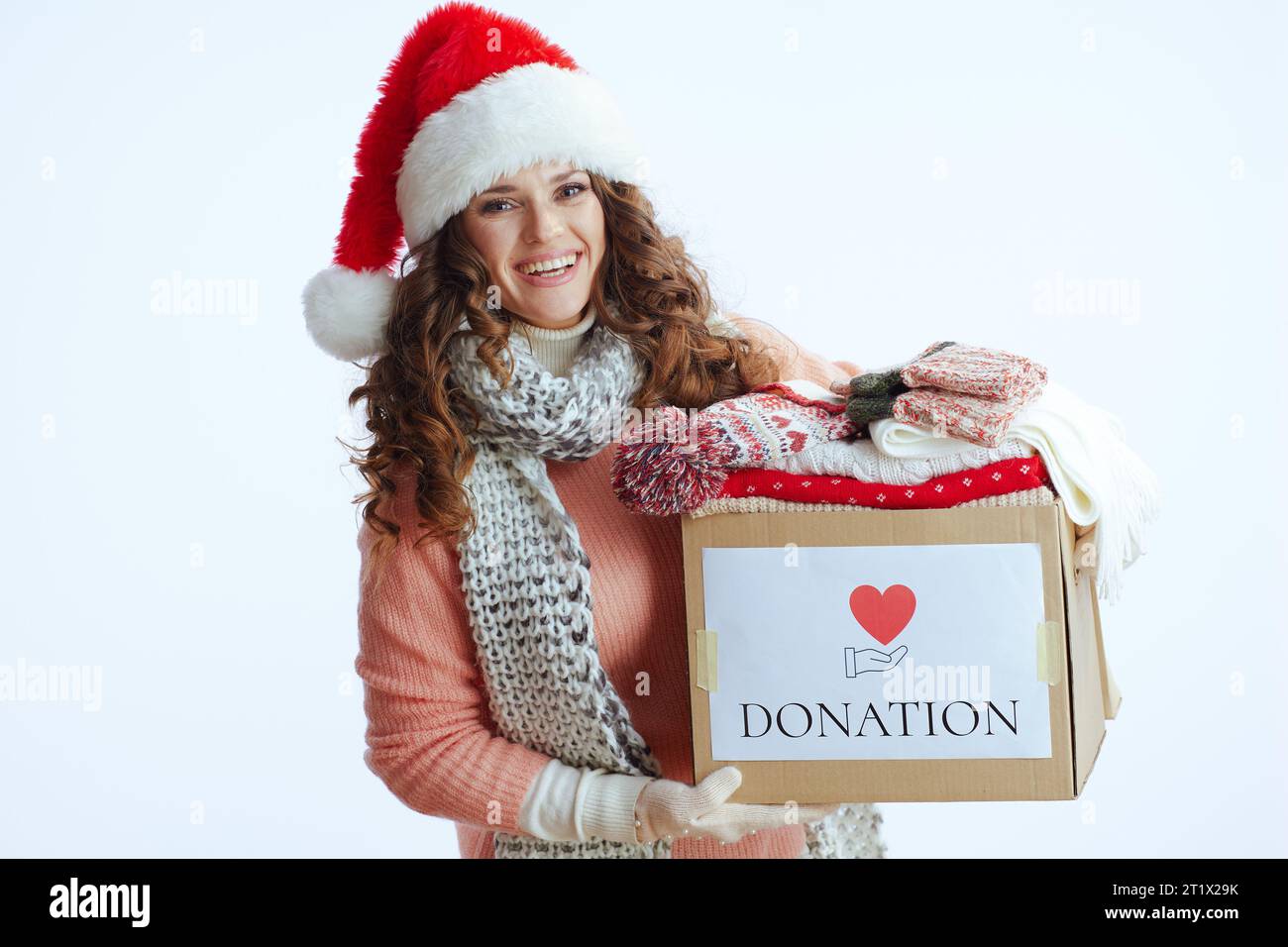 Hello winter. happy modern 40 years old woman in sweater, mittens, hat ...