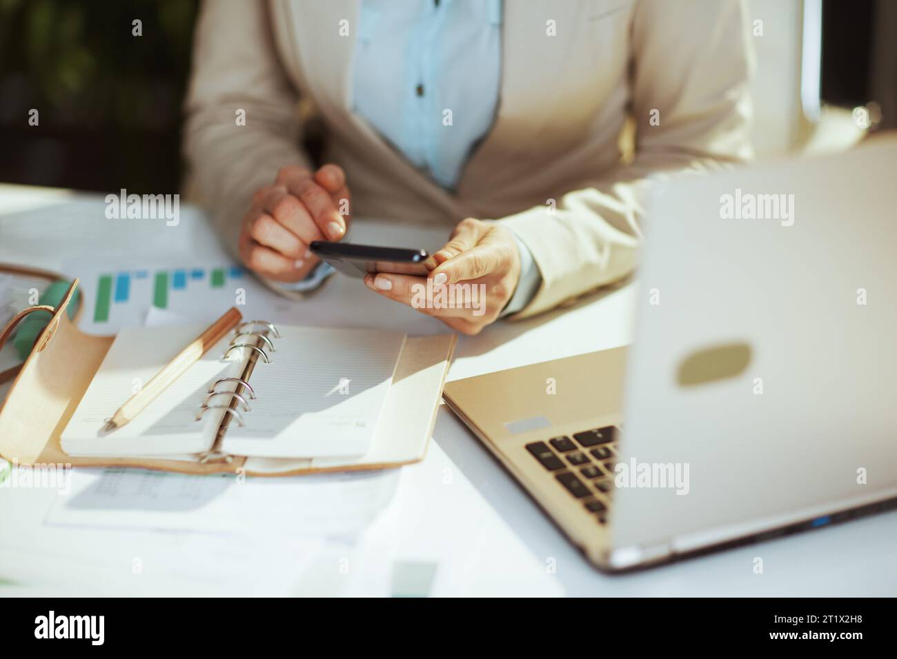 Closeup on accountant woman in a light business suit in green office ...