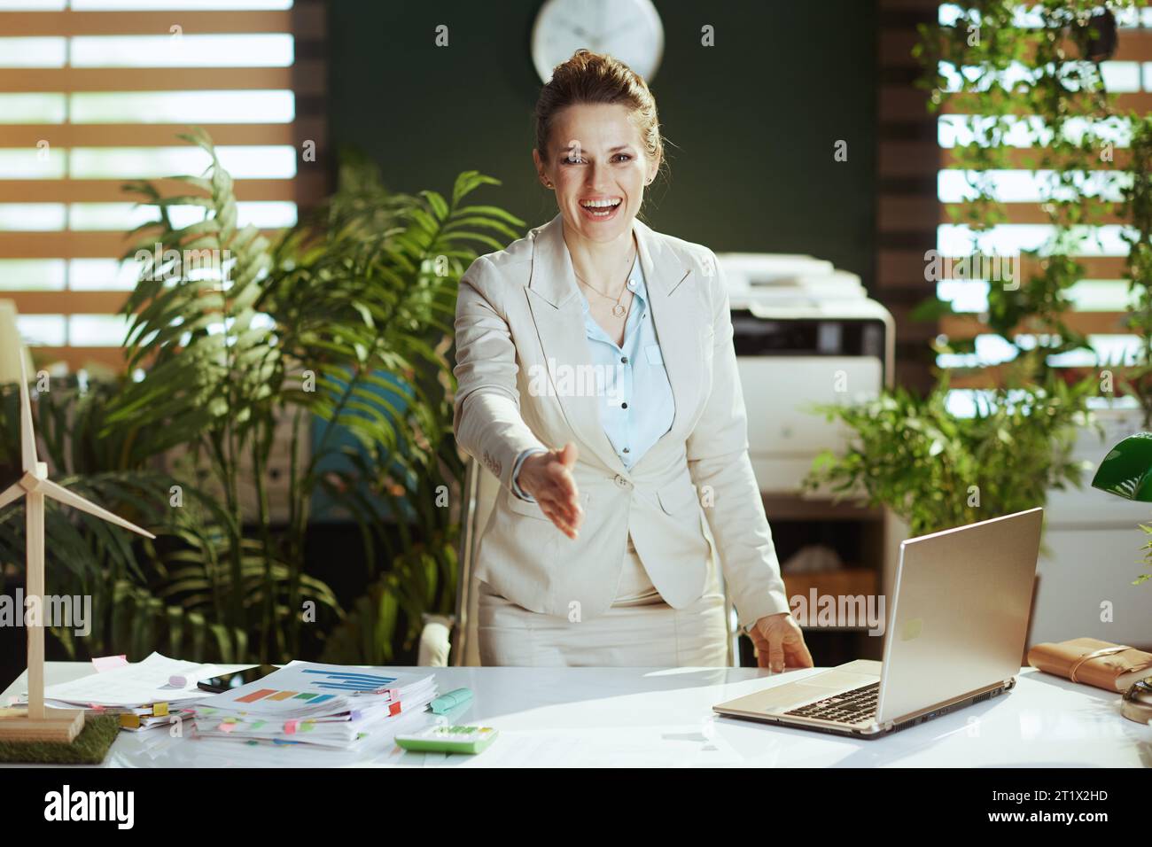 Portrait of smiling modern small business owner woman in a light ...
