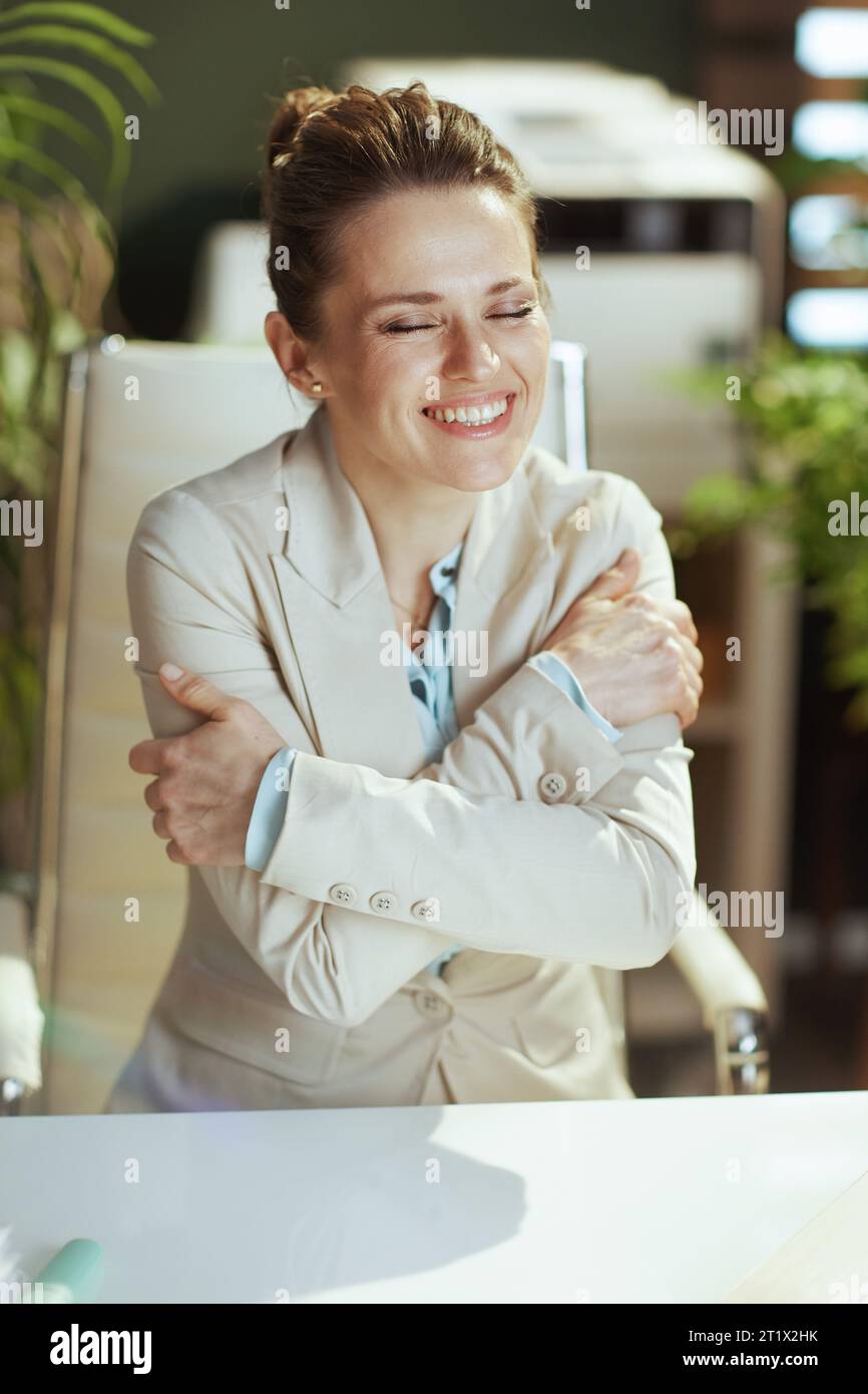 happy modern small business owner woman in a light business suit in ...