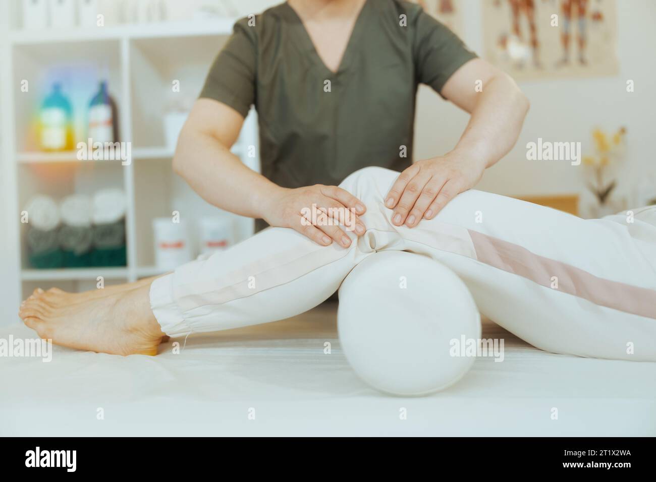 Healthcare time. Closeup on massage therapist woman in massage cabinet with client doing checkup ...