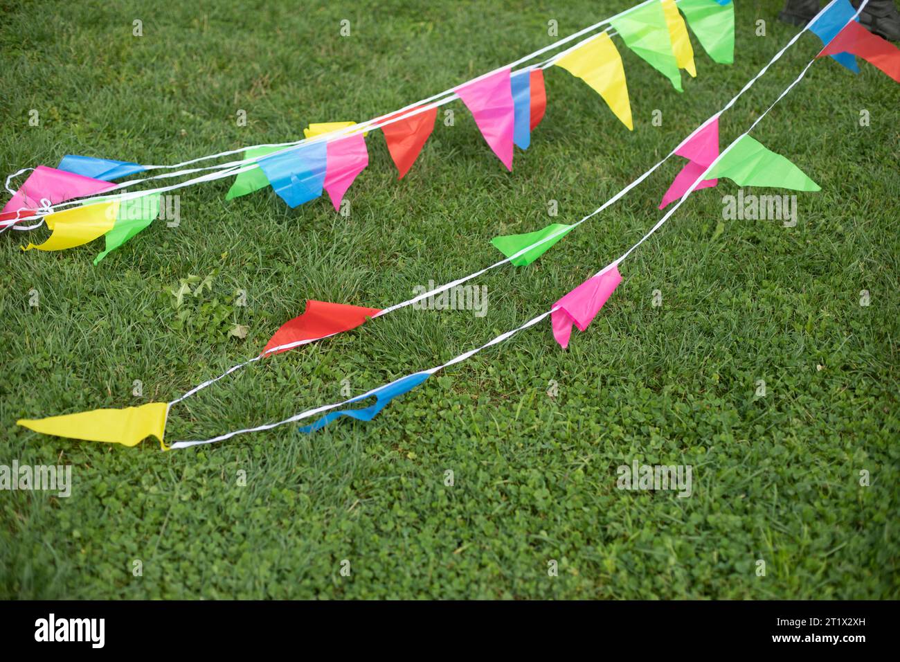 Flags on a rope. Flags of different colors on the ropes. Details of the ...