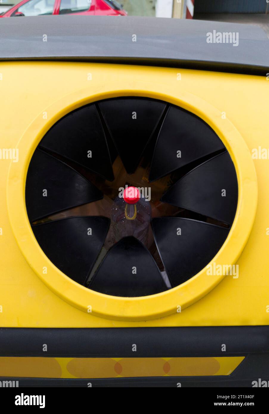 Red cap bottle inside yellow dumpster. Selective focus Stock Photo - Alamy