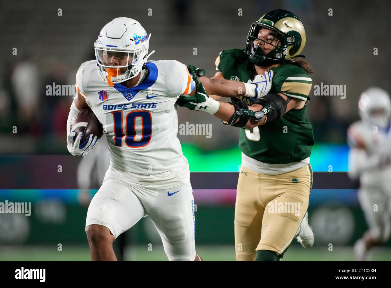 After intercepting a pass, Boise State linebacker Andrew Simpson (10) holds off a tackle by ...