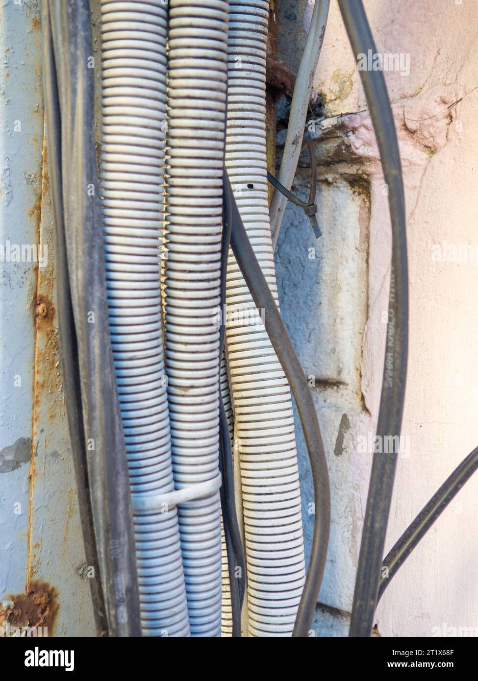 Electrical wiring on the wall outside. Sheathed wires. Energy supply ...
