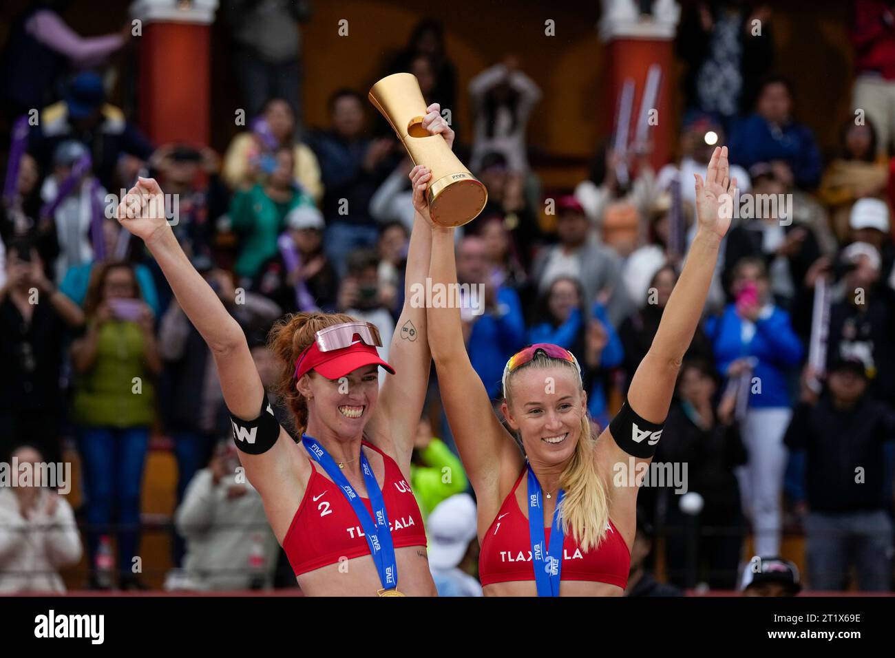 Sara Hughes, right, and Kelly Cheng, of the United States, hold up ...