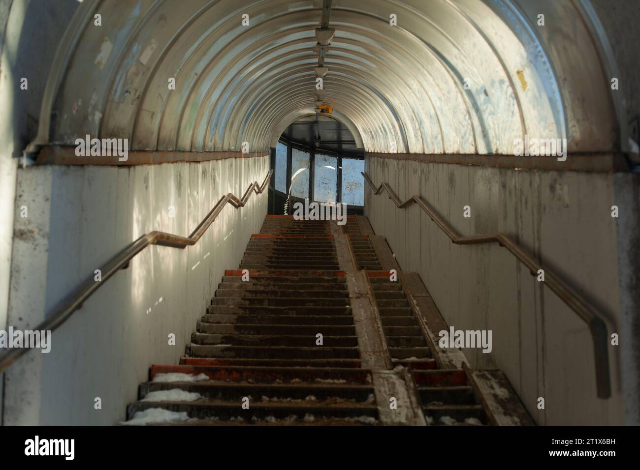 Stairs in city. Tunnel to top. Steps in snow. Pedestrian crossing over ...